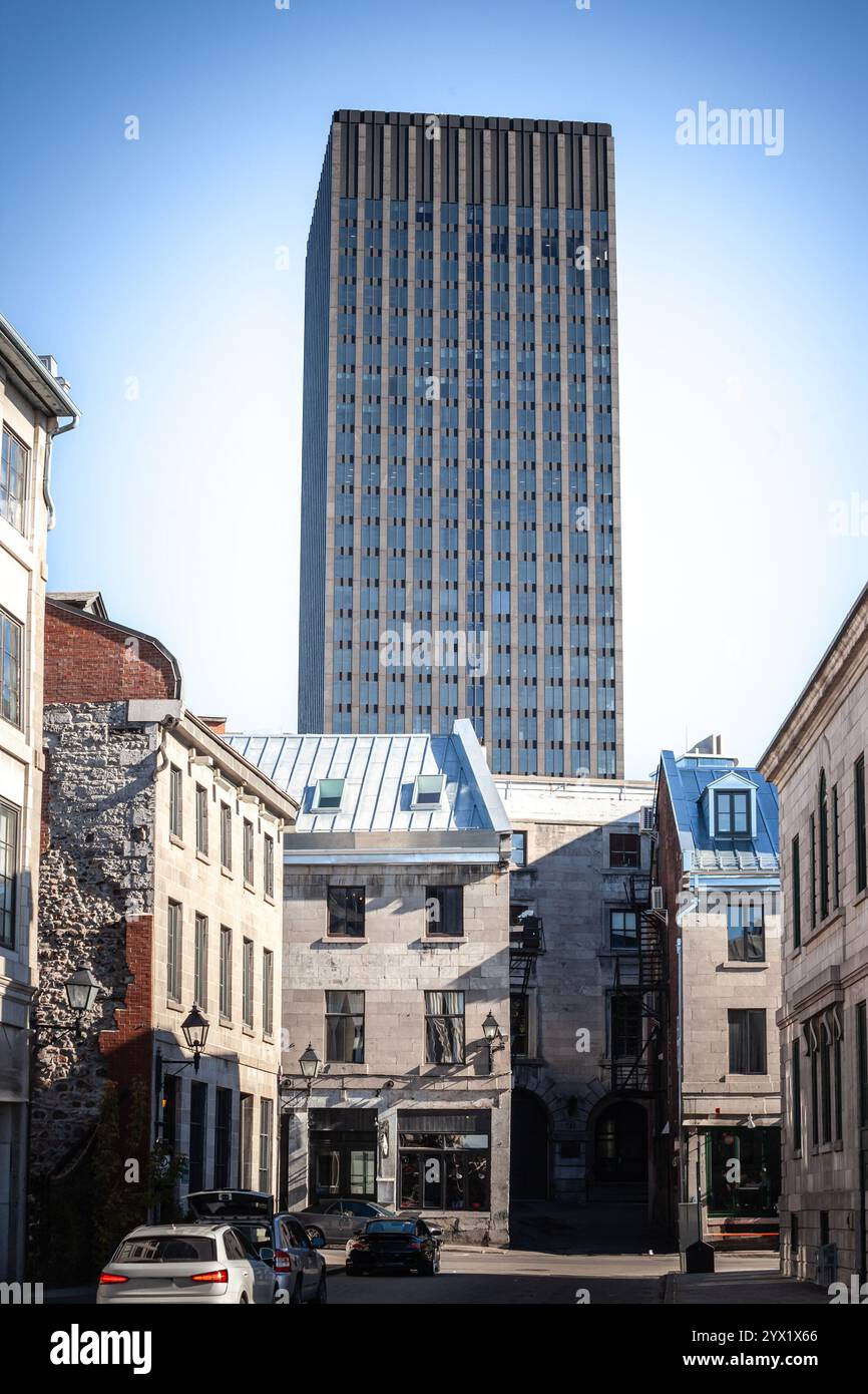 In Old Montreal (Vieux Montreal, Quebec, Canada), a skyscraper towers ...