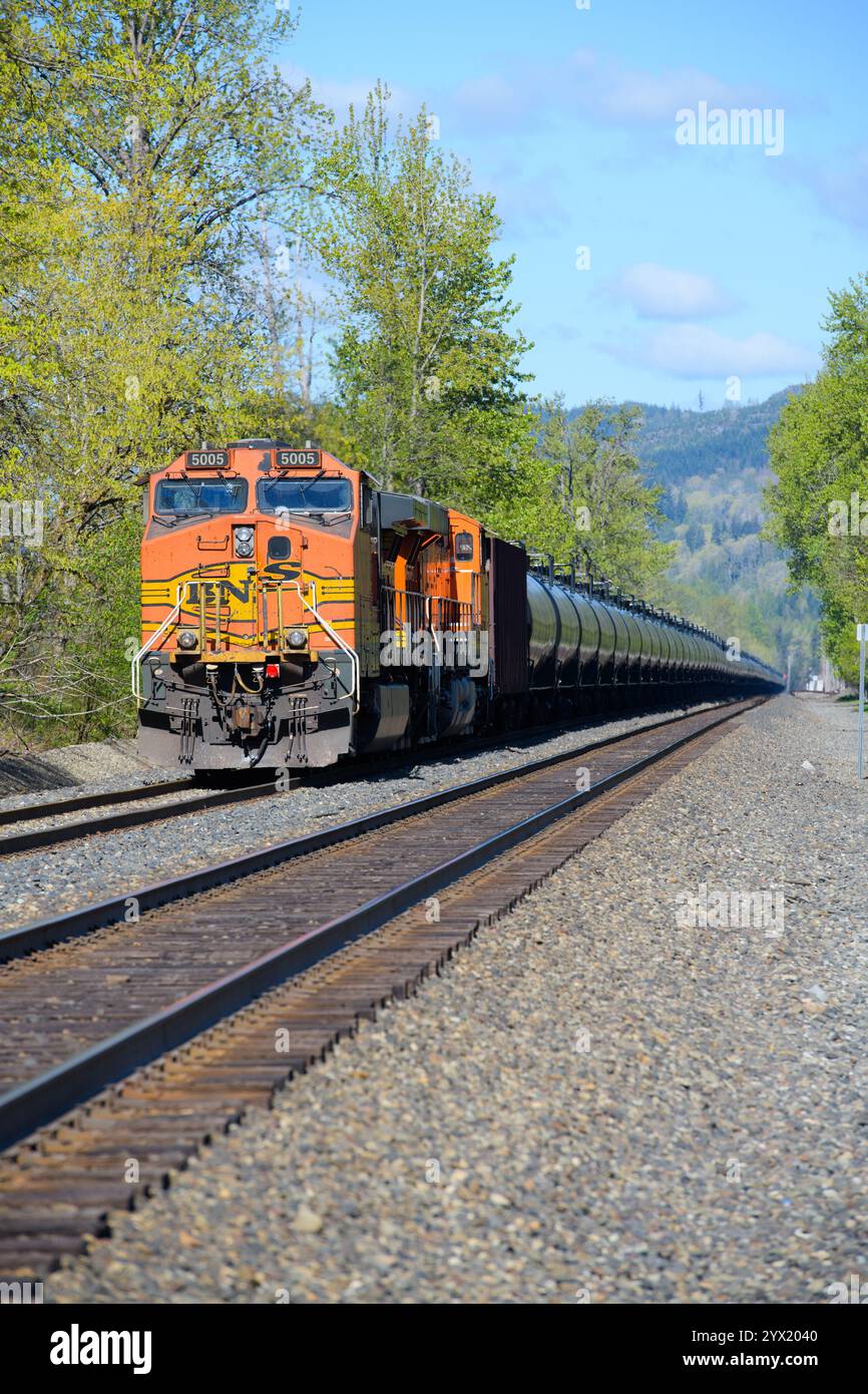 Gold Bar, WA, USA - April 17, 2024; BNSF petroleum crude oil tanker train approaching on ...
