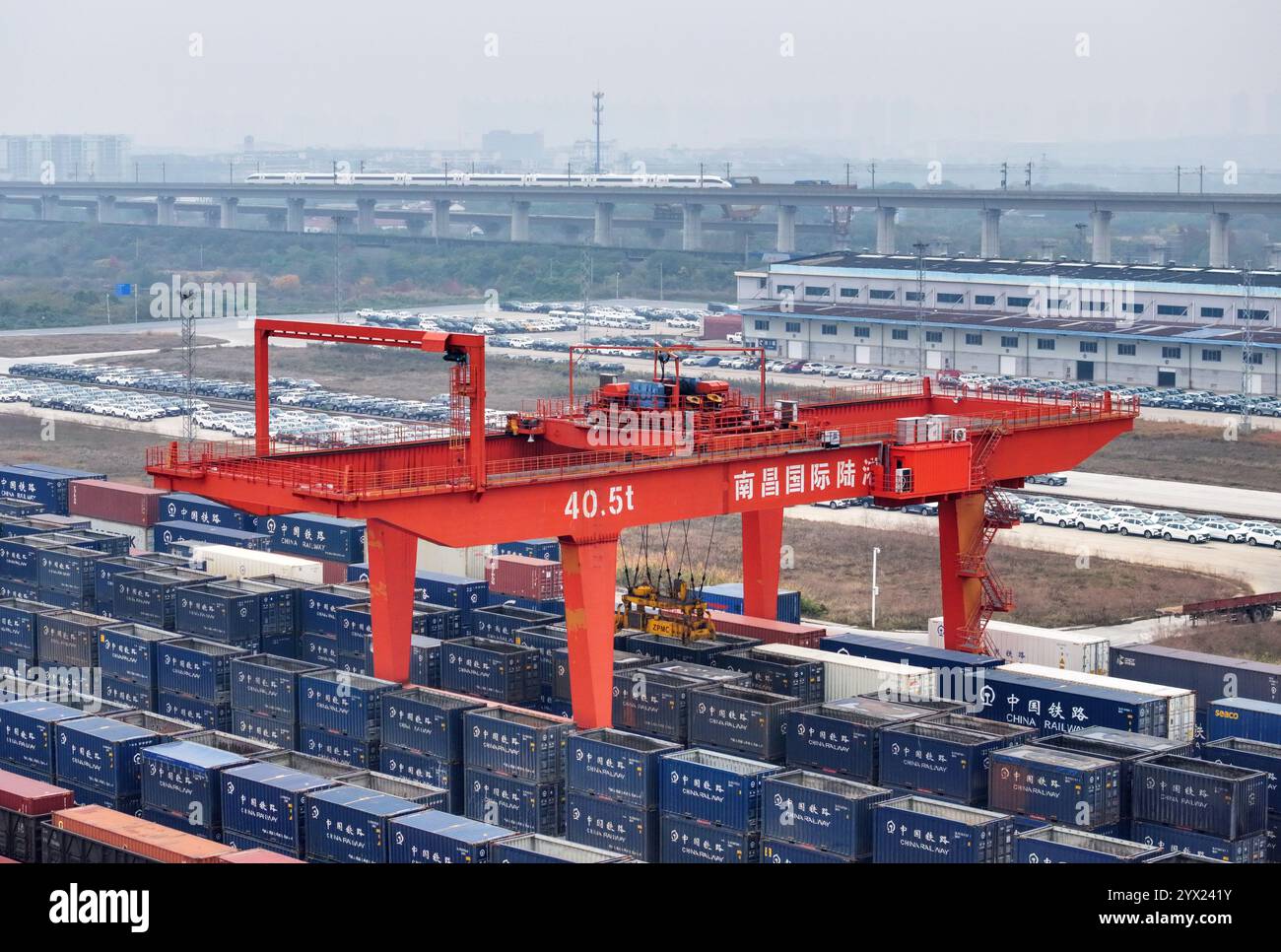Cranes load import and export cargo containers at the Nanchang ...