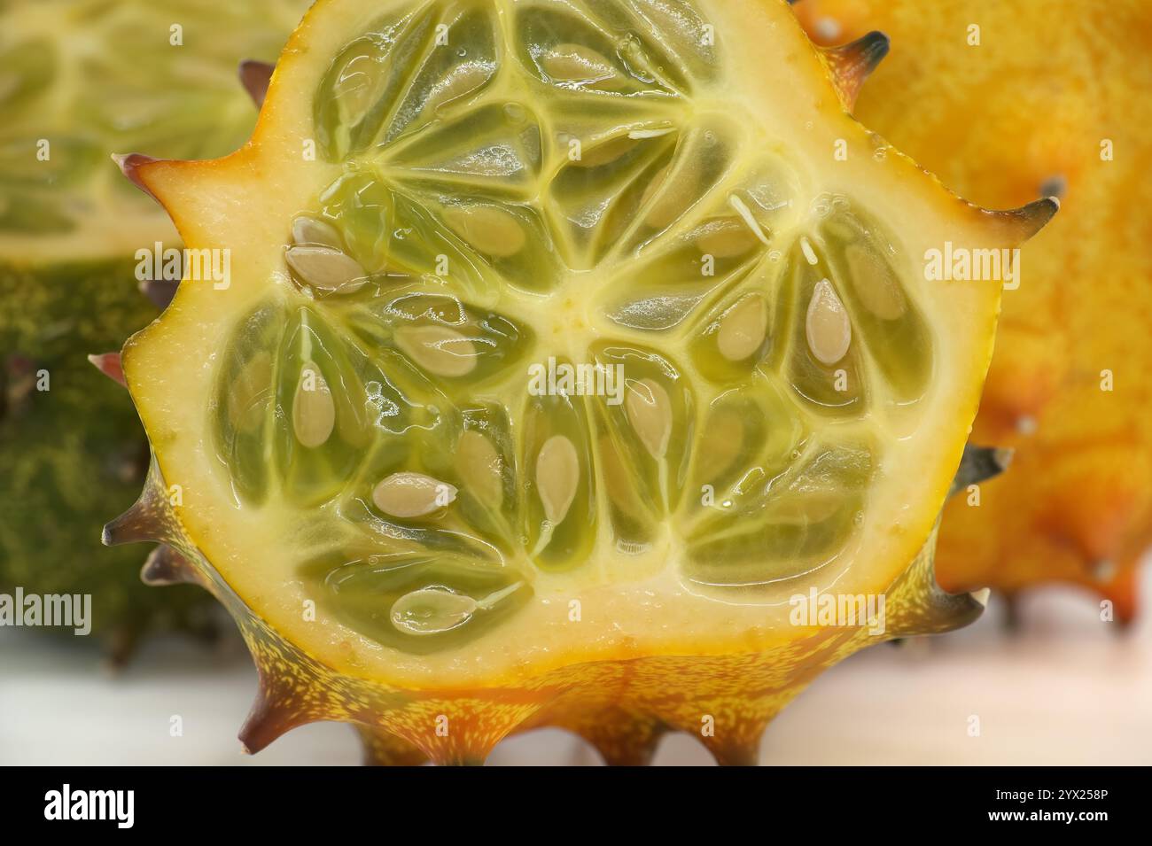 Close-up of a horned melon revealing vibrant green interior and ...