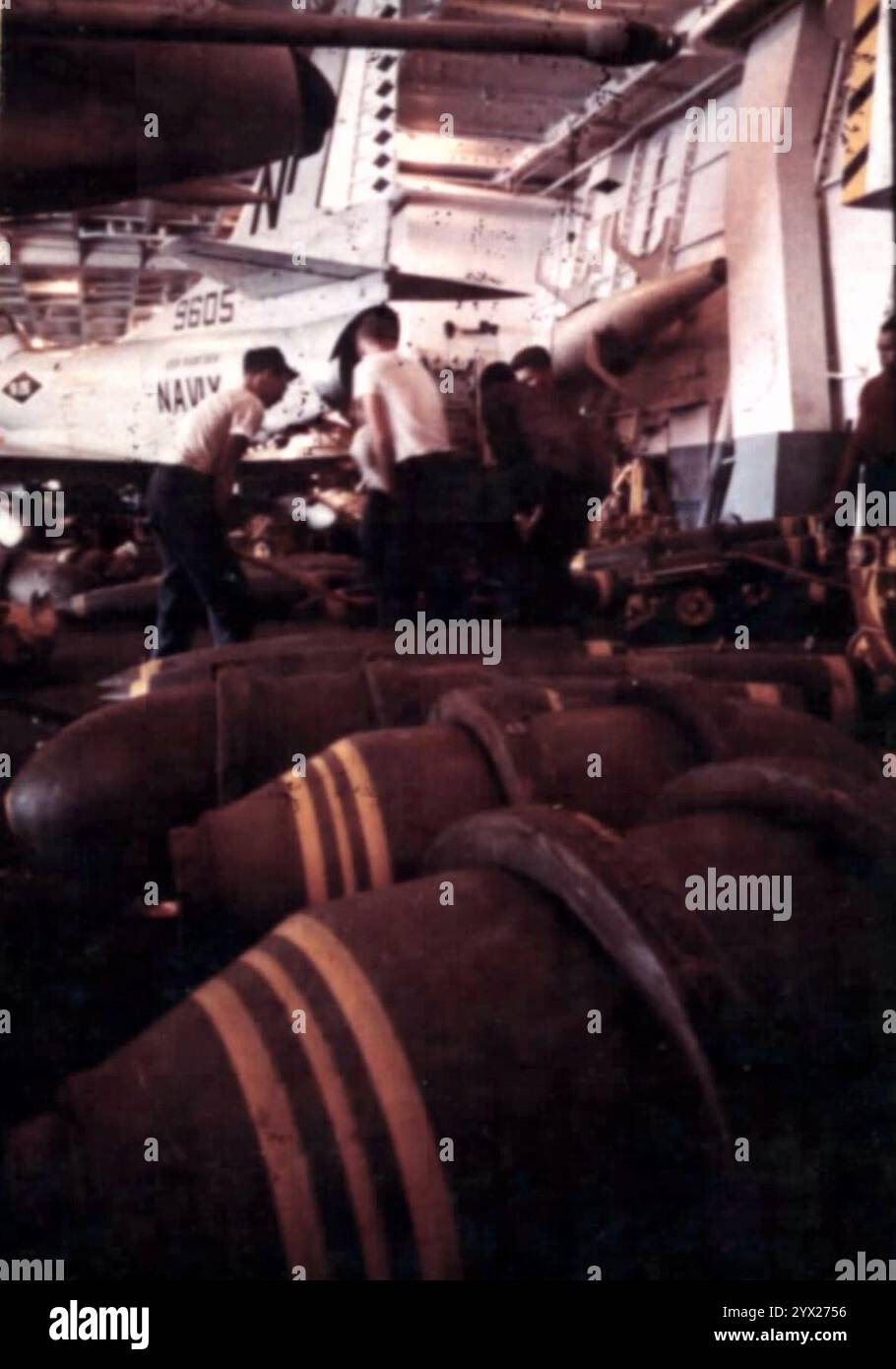 Crewmen aboard USS Hancock (CVA-19) handle bombs, 6 April 1966 (428-GX ...