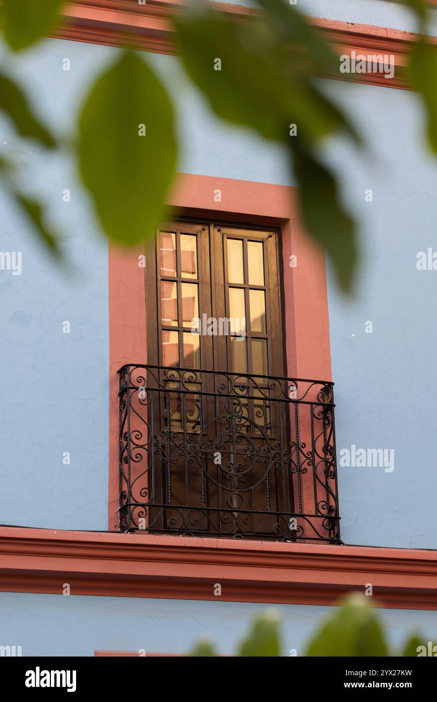 Wrought iron balcony and historic window façade in central Jiquilpan ...