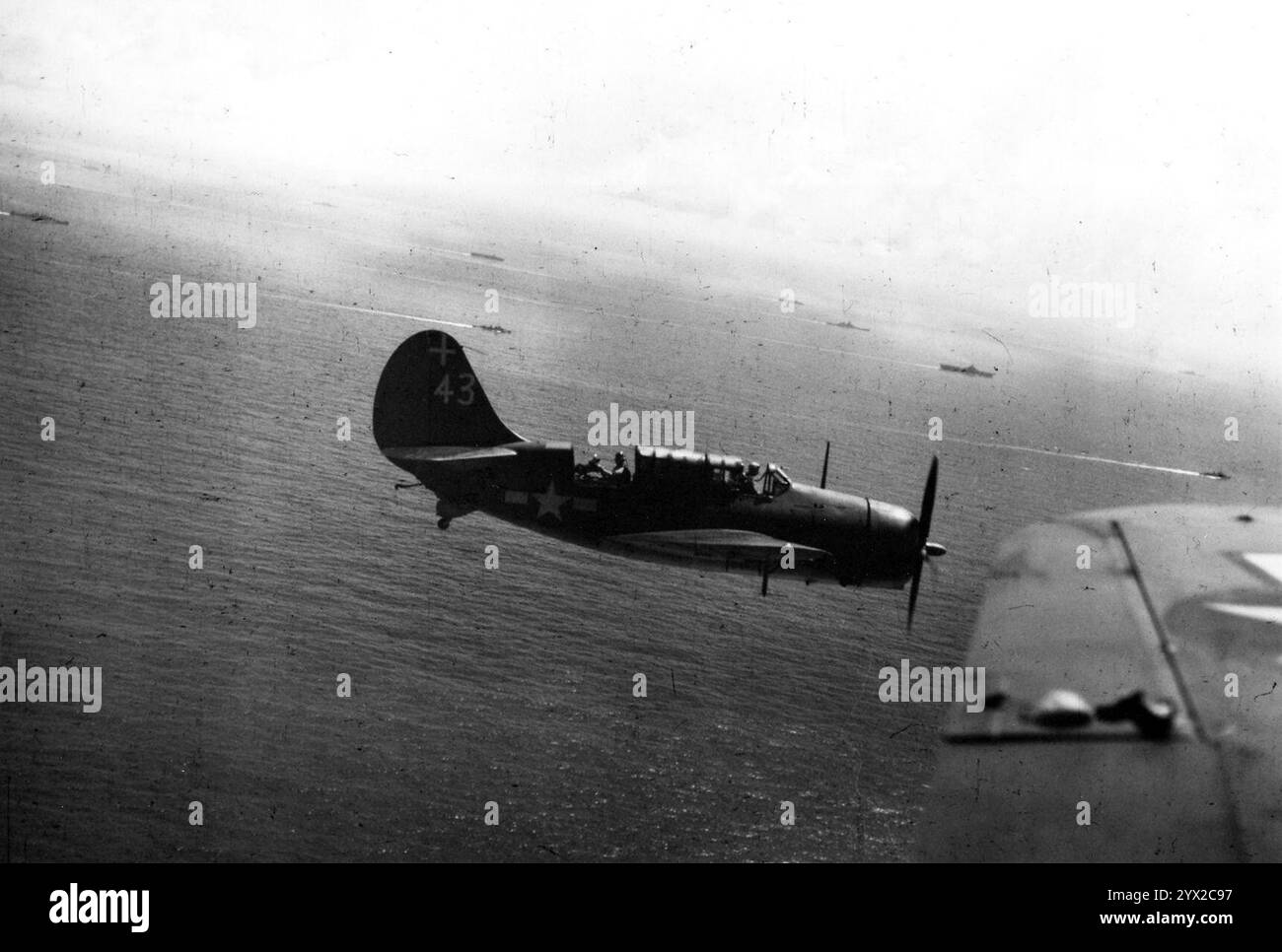 Curtiss SB2C-3 Helldiver of VB-18 in flight over U.S. Task Group 38.2 ...