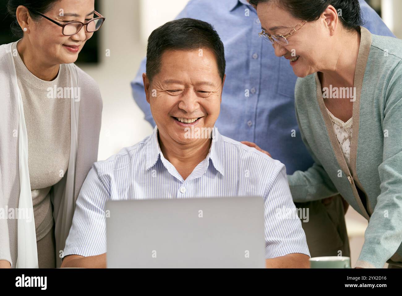 two happy asian couples using laptop computer together at home Stock ...