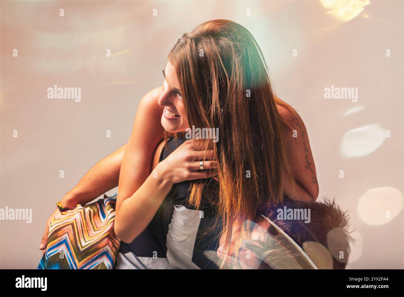 In a heartwarming display of affection, a young woman smiles brightly ...