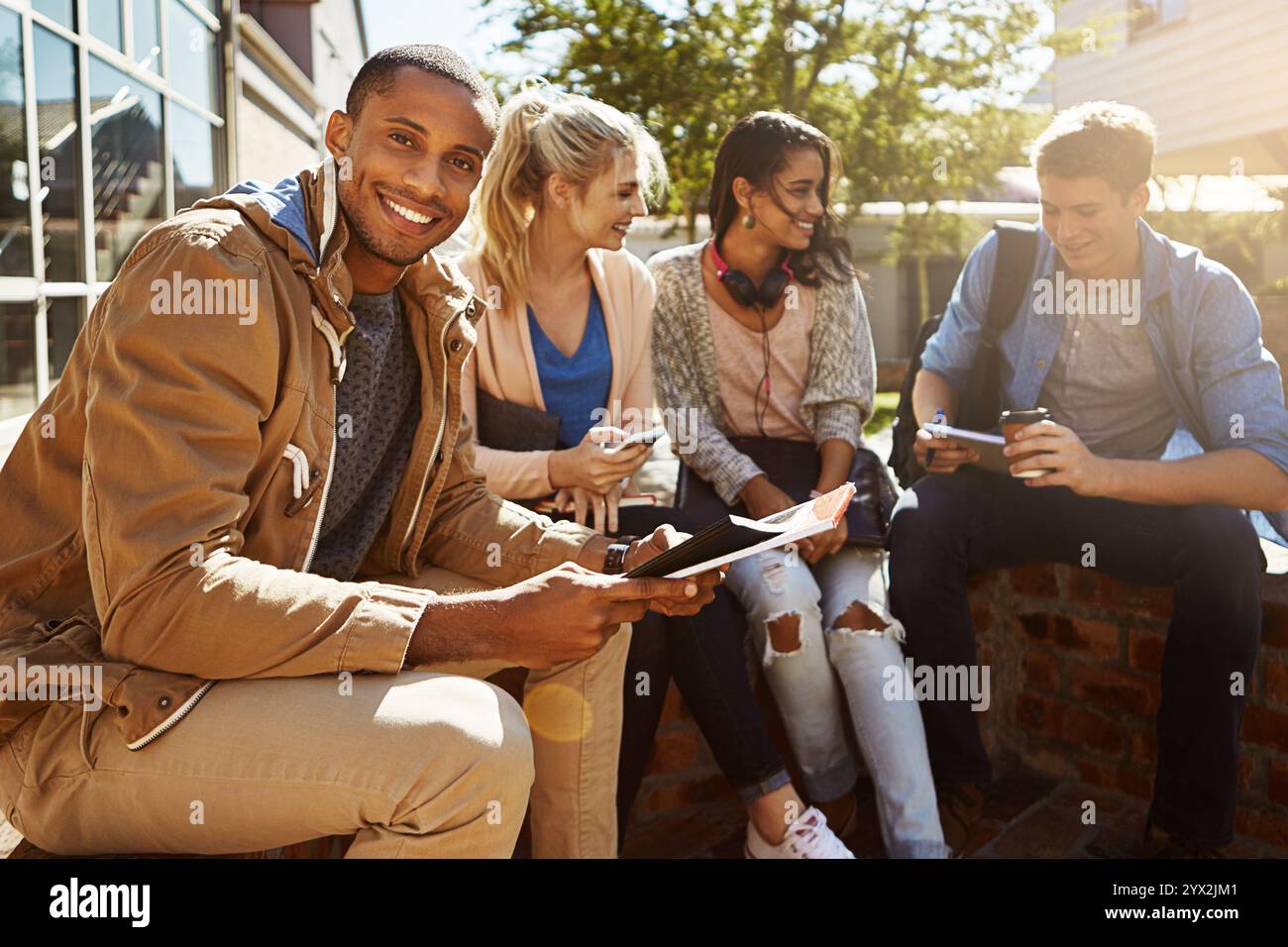 Happy, man and college with students in outdoor for studying, education ...
