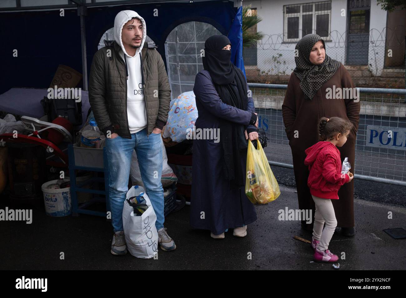 Syrian families wait at the border crossing. On December 8, 2024 ...