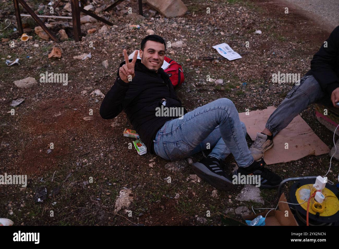 Hatay, Turkey. 12th Dec, 2024. A Syrian refugee strikes a victory pose ...