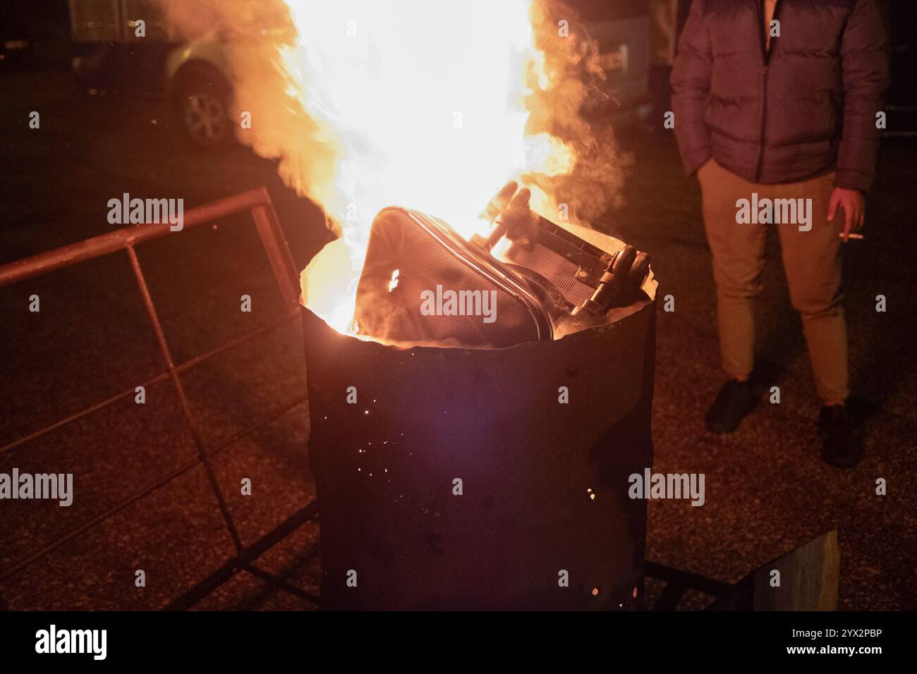 Syrian refugees keep warm by burning a suitcase that a family couldn't ...
