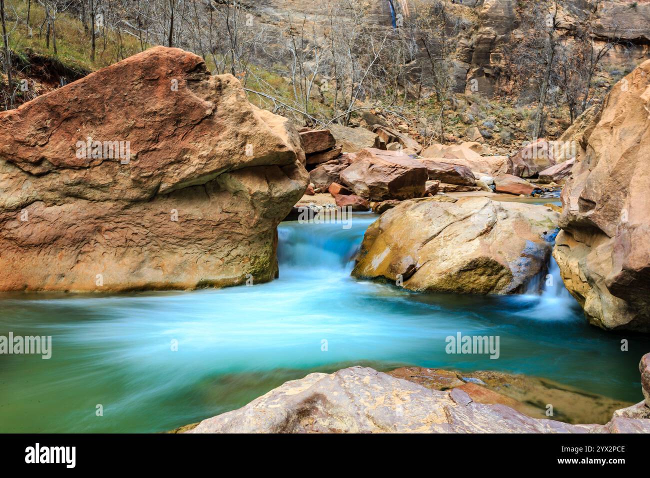 A river flows through a rocky canyon, with the water appearing blue and ...