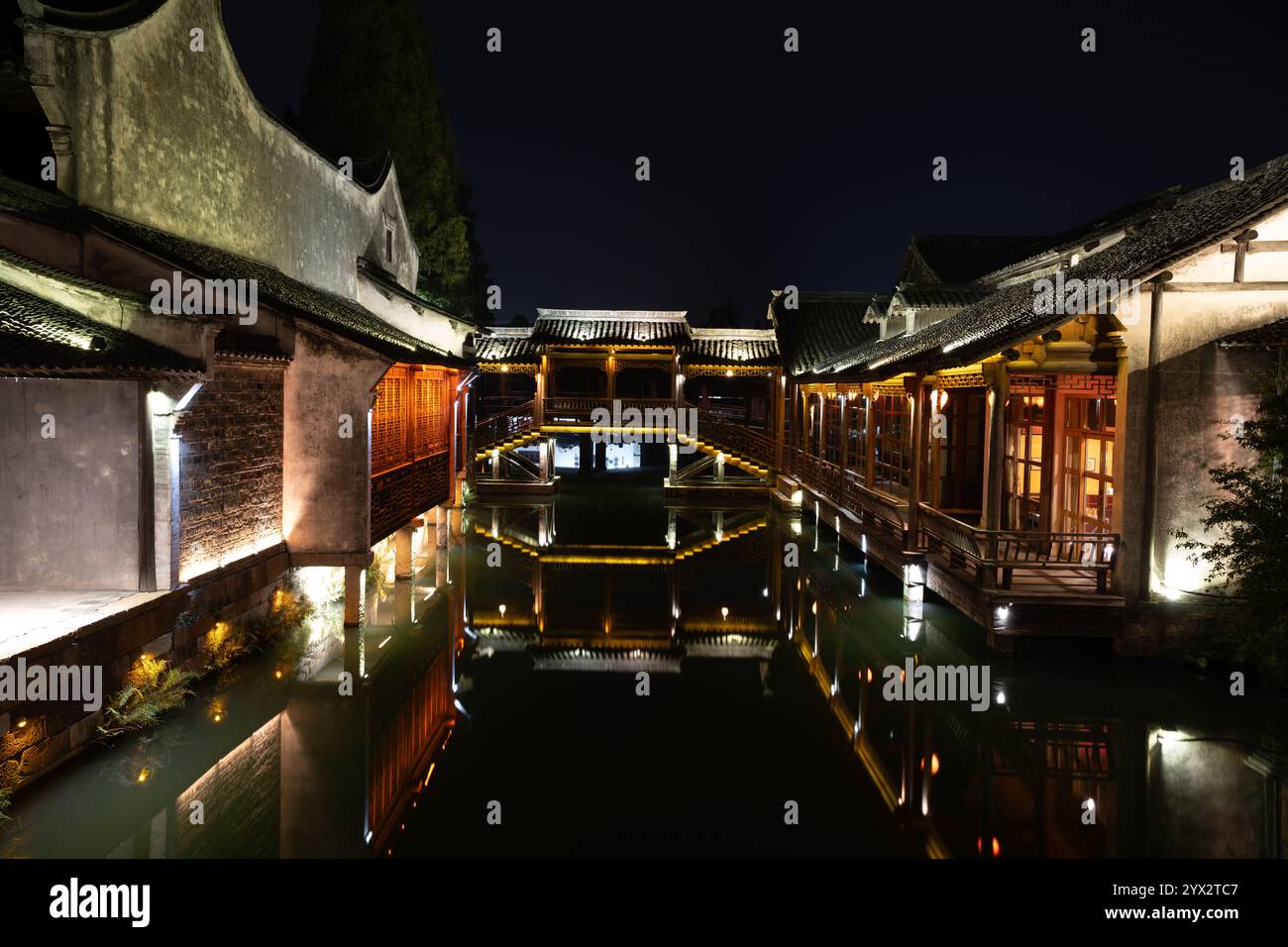 Reflections of traditional Wuzhen architecture in the tranquil night ...