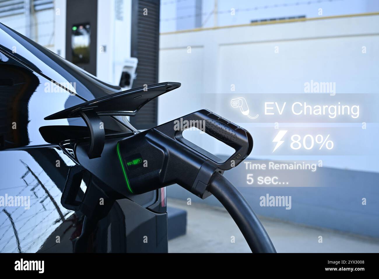 Electric vehicle charging at station with digital interface displaying ...