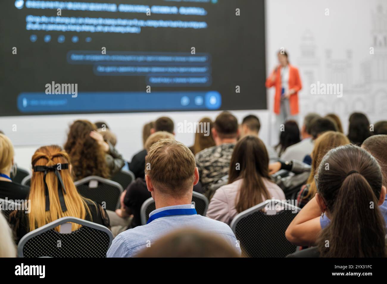 Focused crowd attending lecture presented by professional speaker in ...