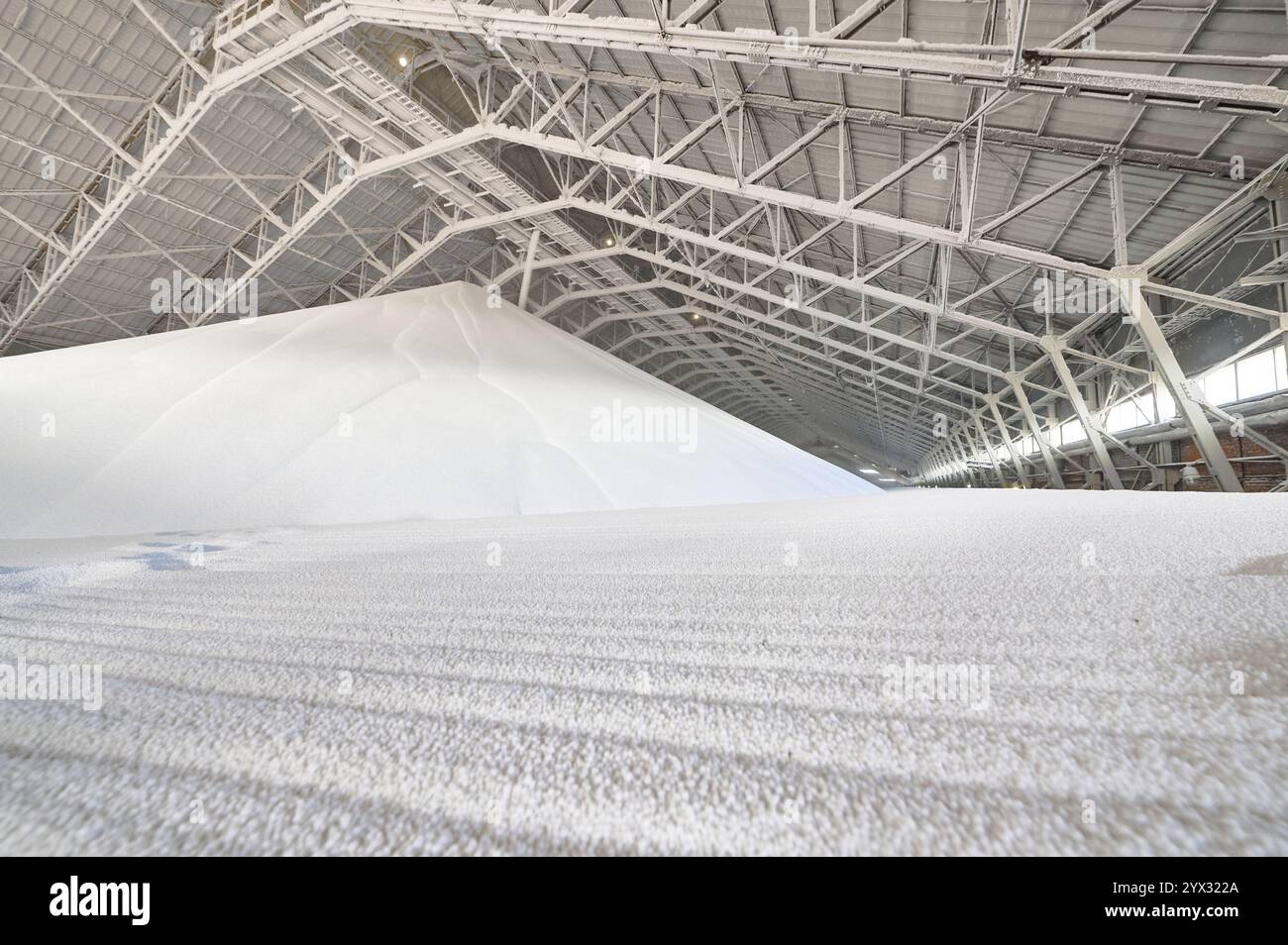 Large chemical plant warehouse featuring a conveyor system transporting ...
