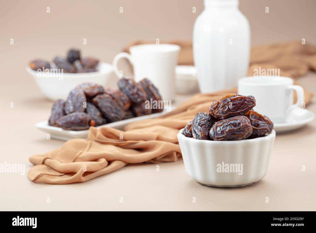 Dried medjool dates in white dish on a beige background Stock Photo - Alamy