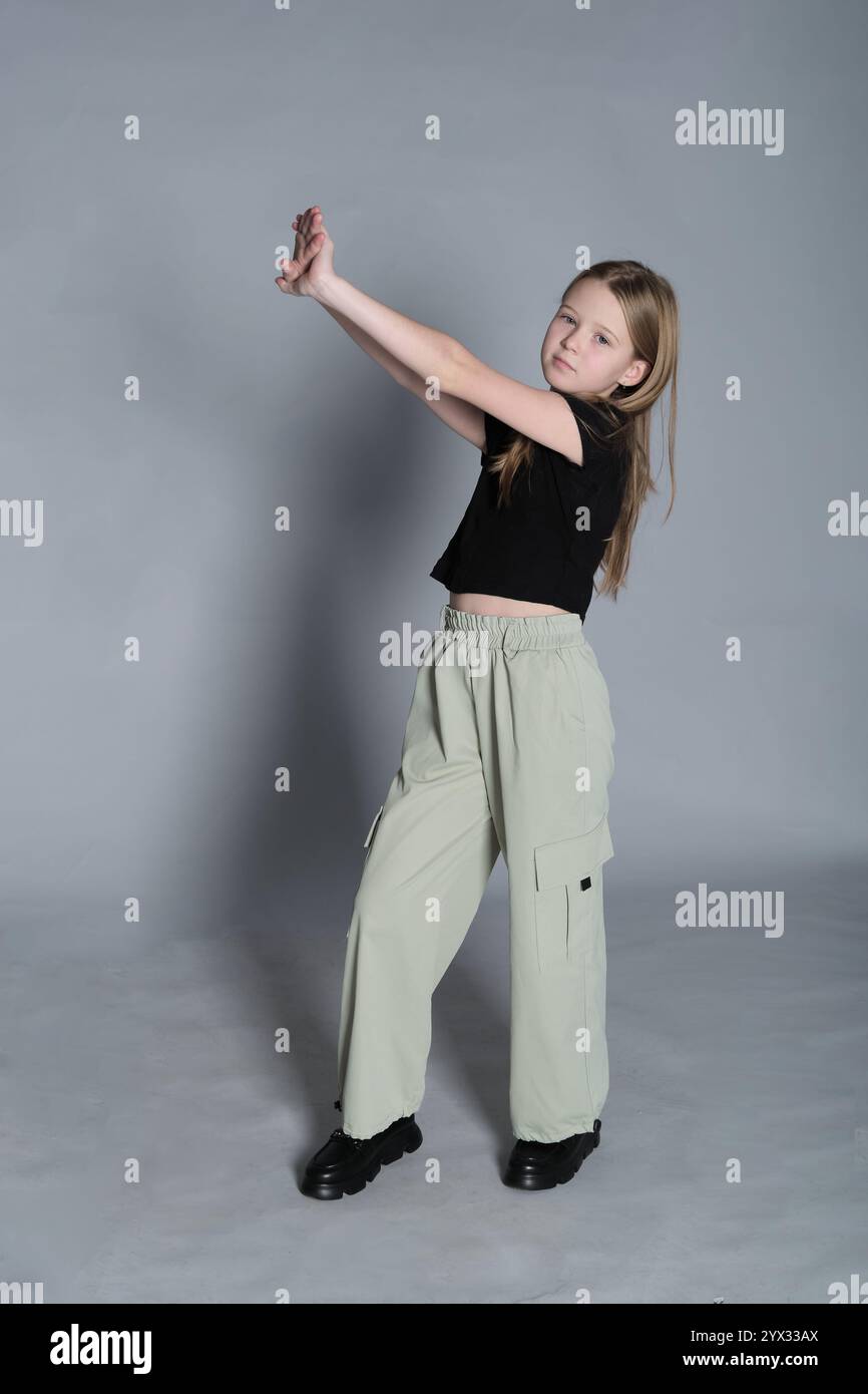 Child in a dance pose, expressing freedom and energy. Her stance ...