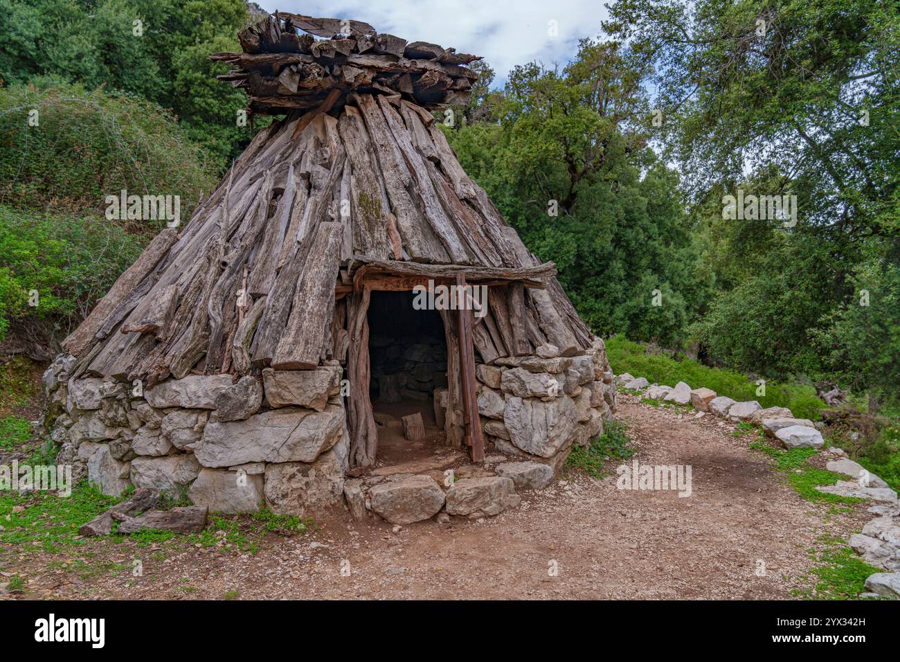 A view of an old shepherd's hut made of stones and wood, hidden in the ...