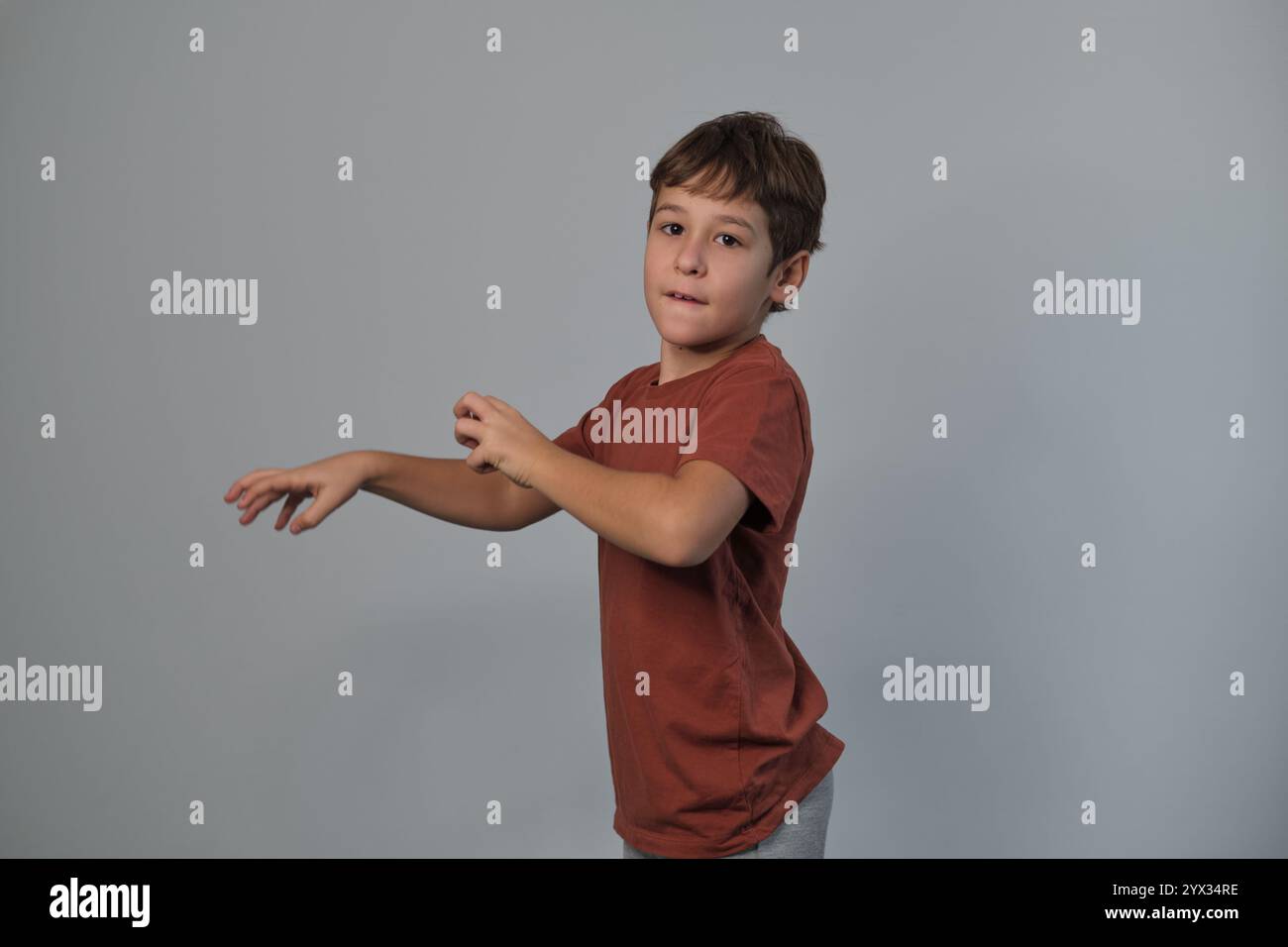 A child expressing playful energy through a unique pose, capturing ...