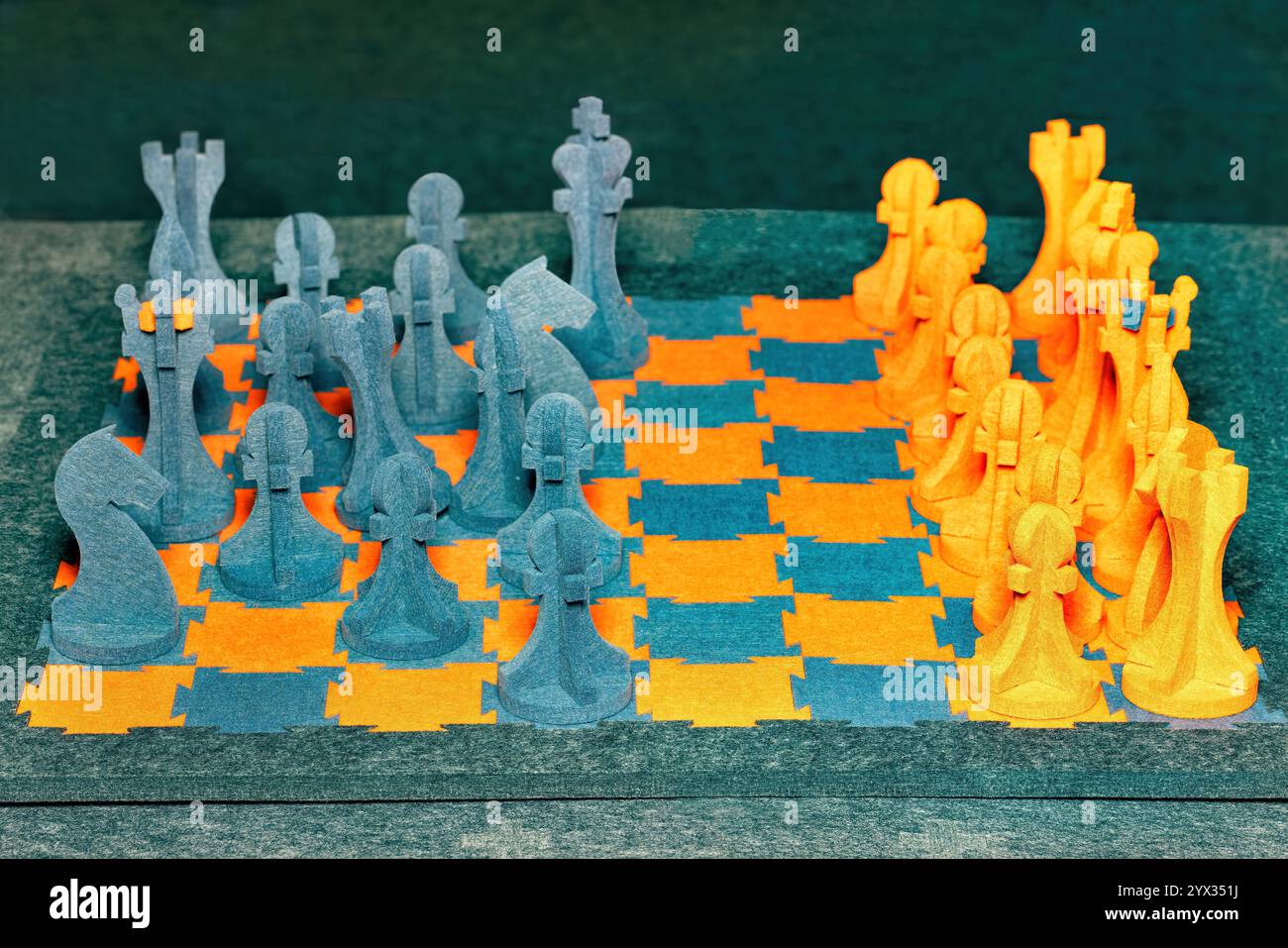 Unique chess set with blue and orange pieces on a textured green board ...