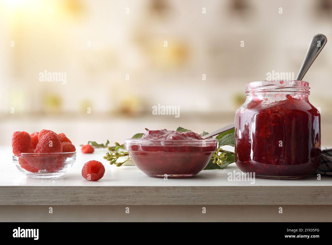 White wooden bench with jars with raspberry jam with fruit berries and ...