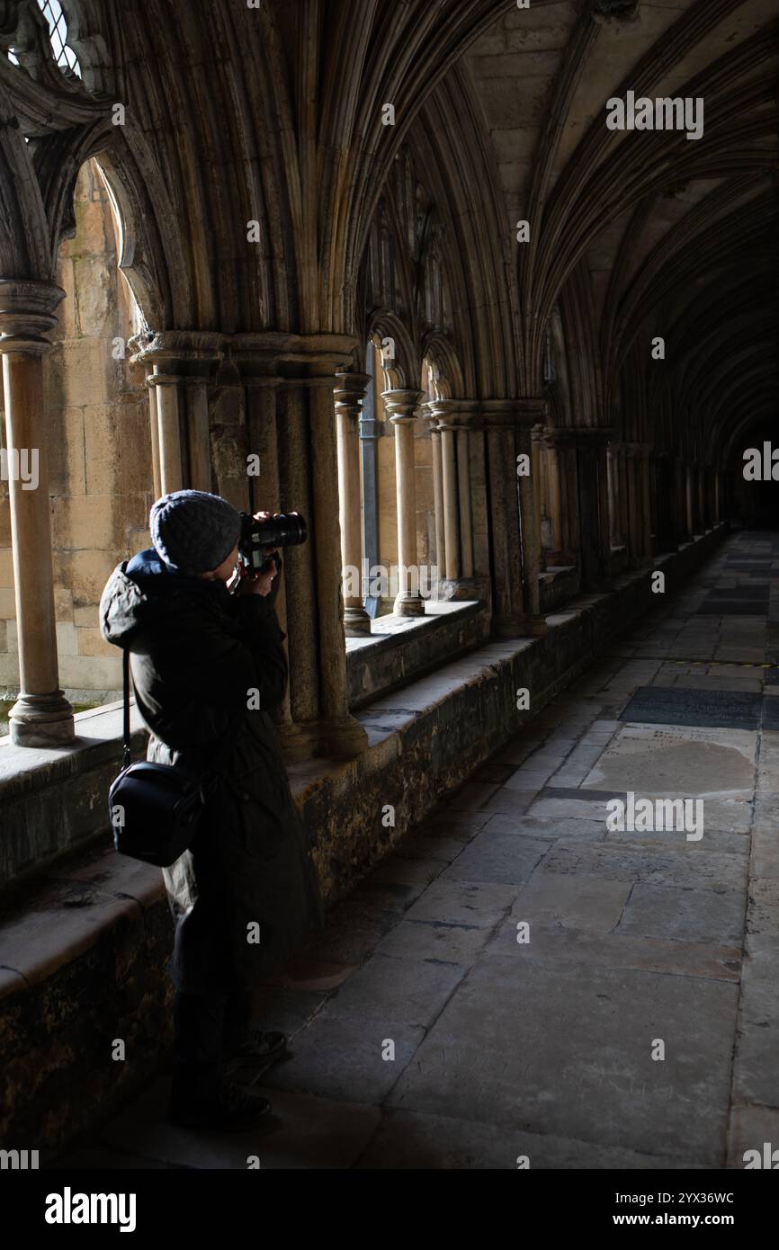 Female photographer taking pictures in the cloisters of Norwich ...