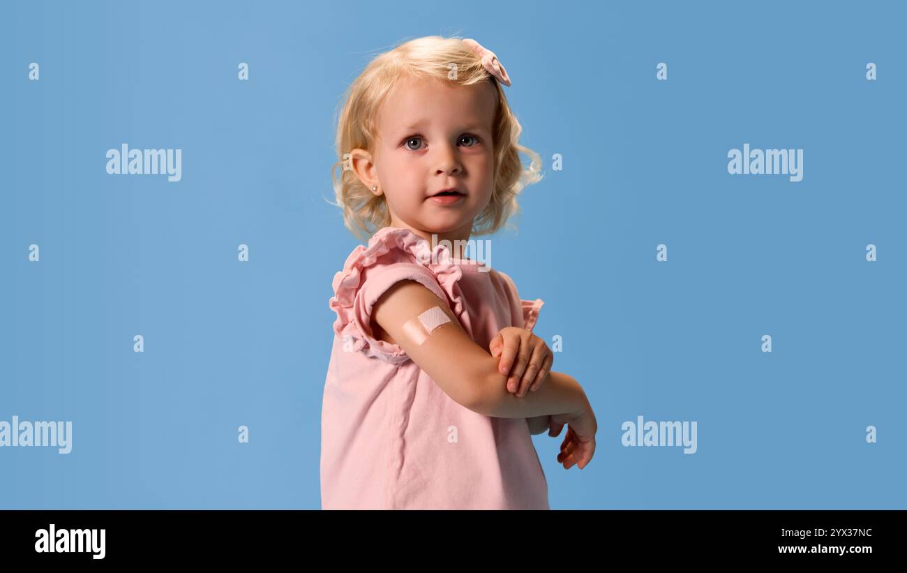 Cute little girl looking at camera and posing demonstrate her hand with ...