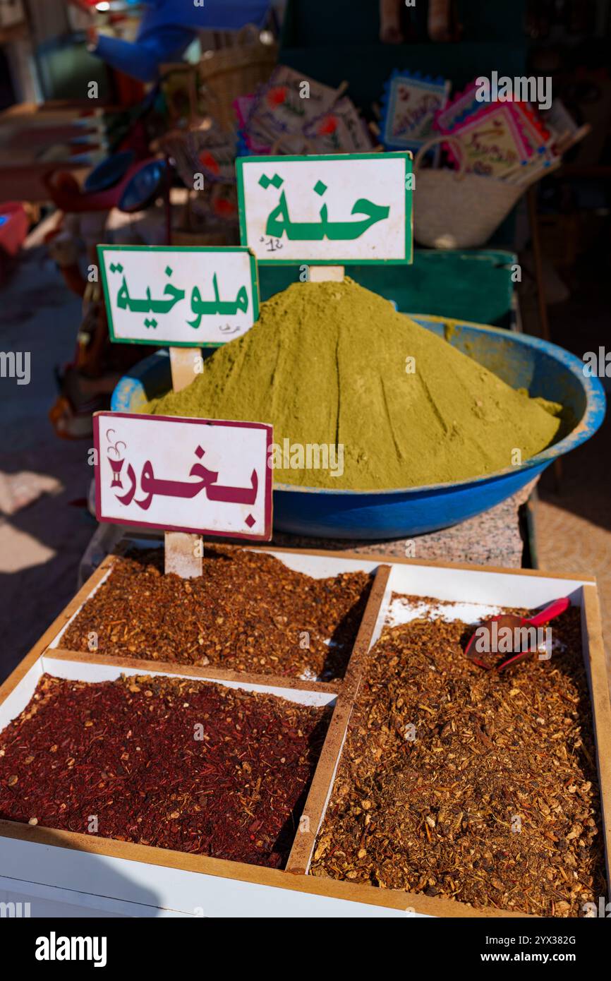 Colorful spices sold in large quantities in a small city market ...