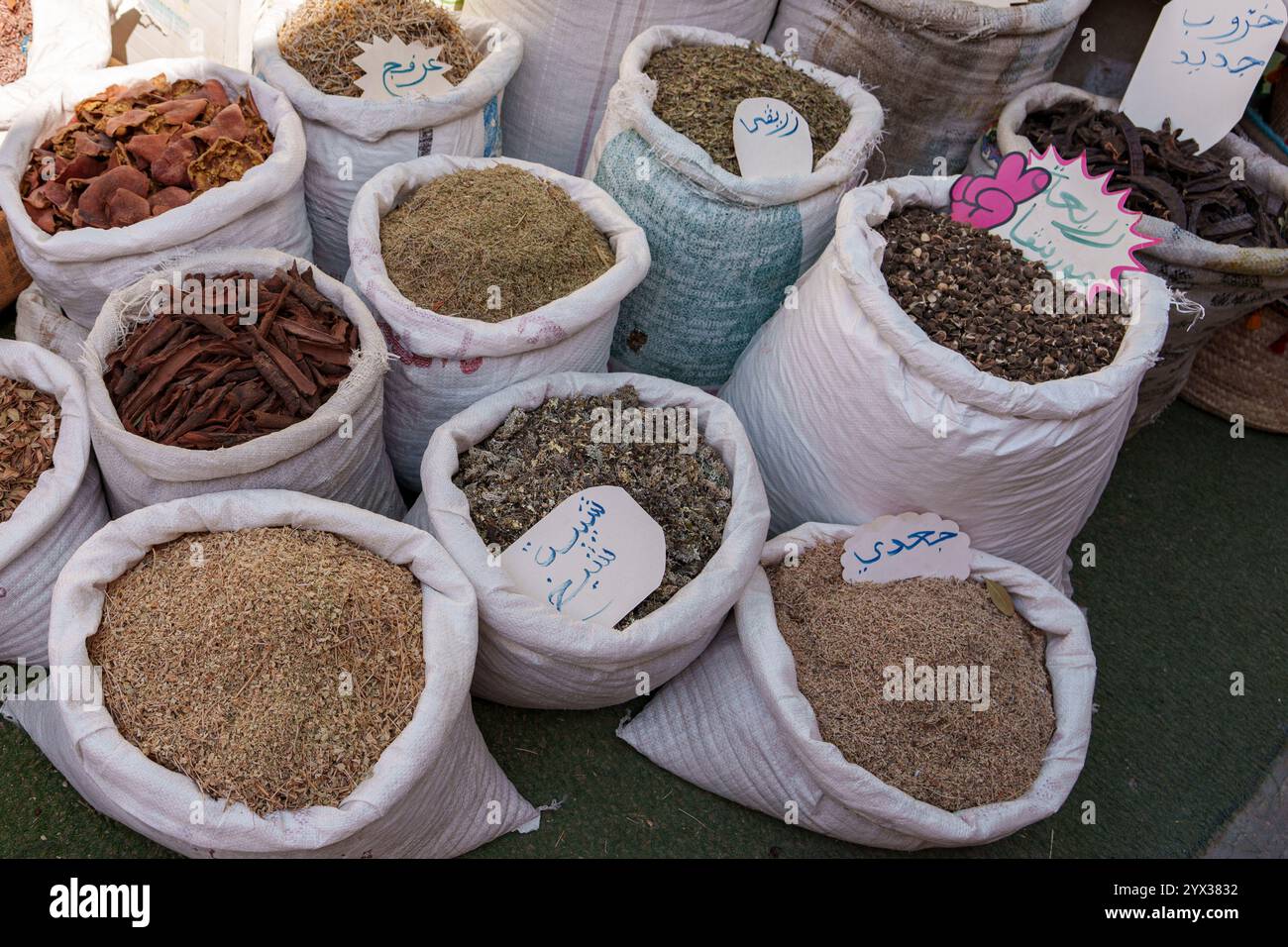 Colorful spices sold in large quantities in a small city market ...