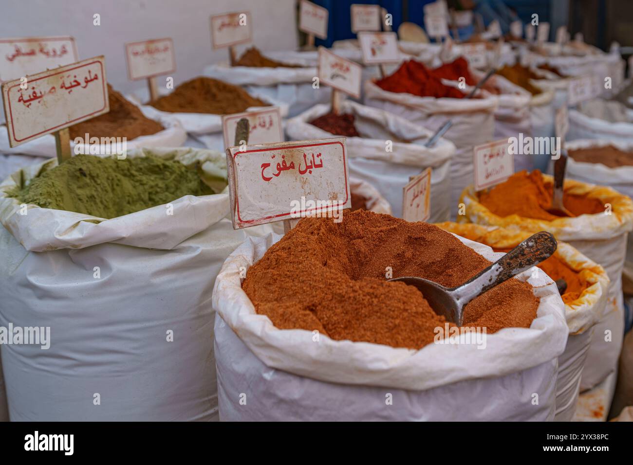 Colorful spices sold in large quantities in a small city market ...