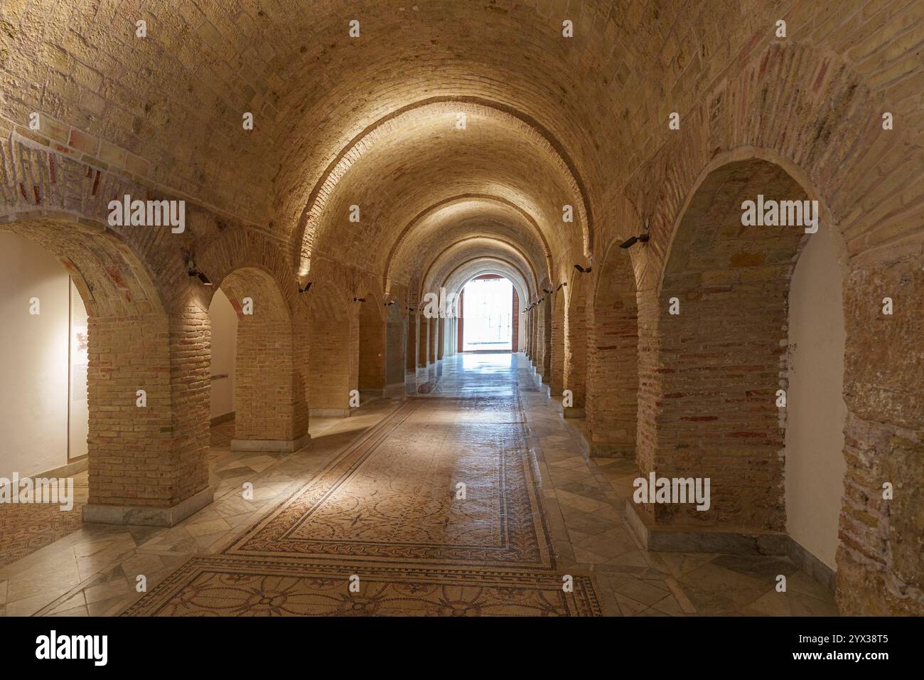 Beautiful arched vaults made of stone create a room with a small window ...