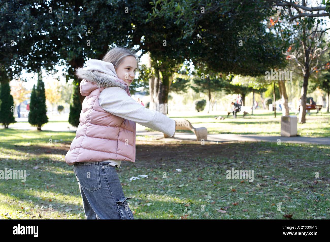 Beautiful happy girl child playing flying disc in a sunny, green ...
