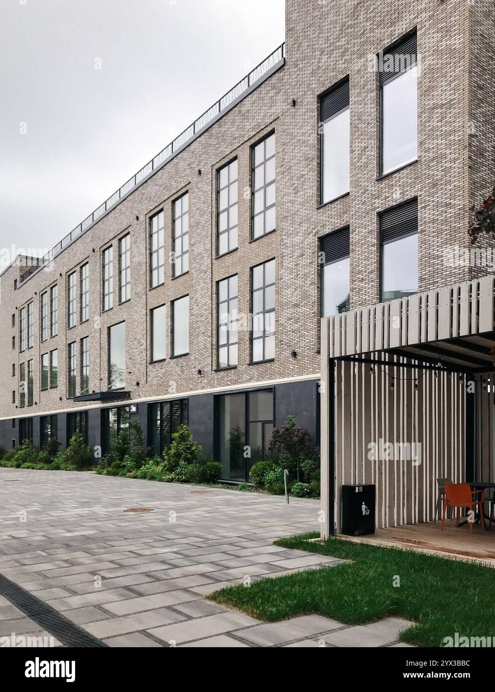 Modern 3-storey brick office building. Inner yard of old factory, now ...