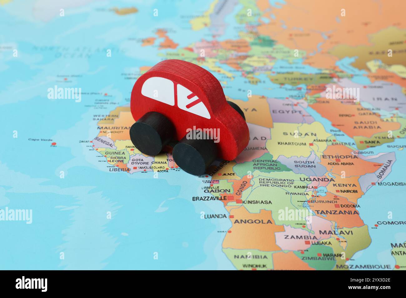 Red wooden toy car on world map. Road trip Stock Photo - Alamy