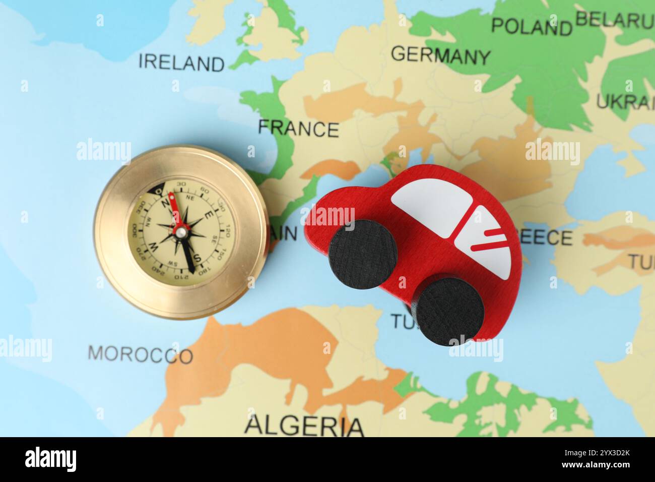 Red wooden toy car and compass on world map, top view. Road trip Stock ...