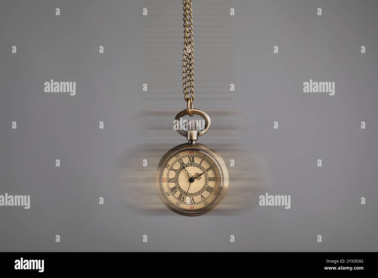 Hypnosis session. Vintage pocket watch swinging on grey background ...