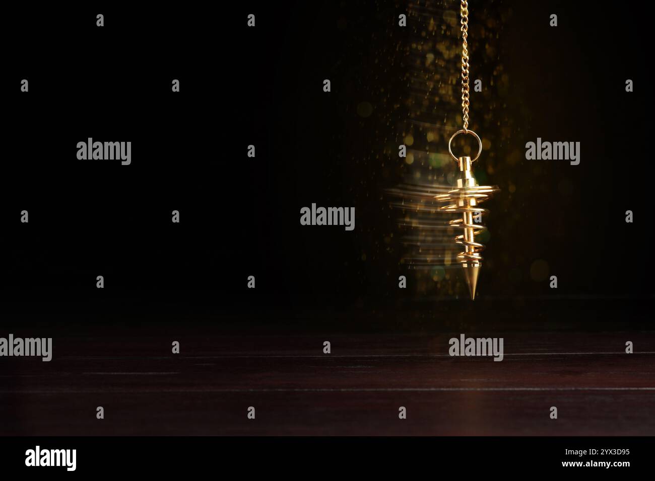 Hypnosis session. Golden pendulum swinging on black background, motion ...