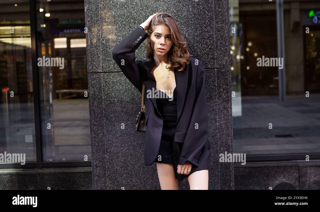 Portrait Stylish young brunette woman with long hair wearing elegant ...