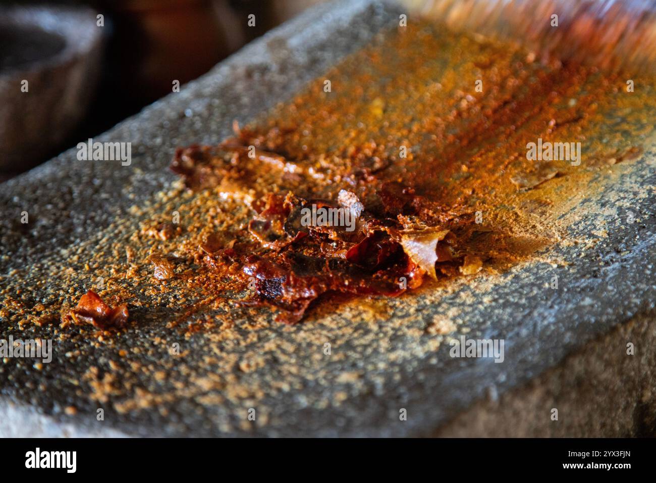 Woman from an indigenous community in Oaxaca preparing traditional red ...