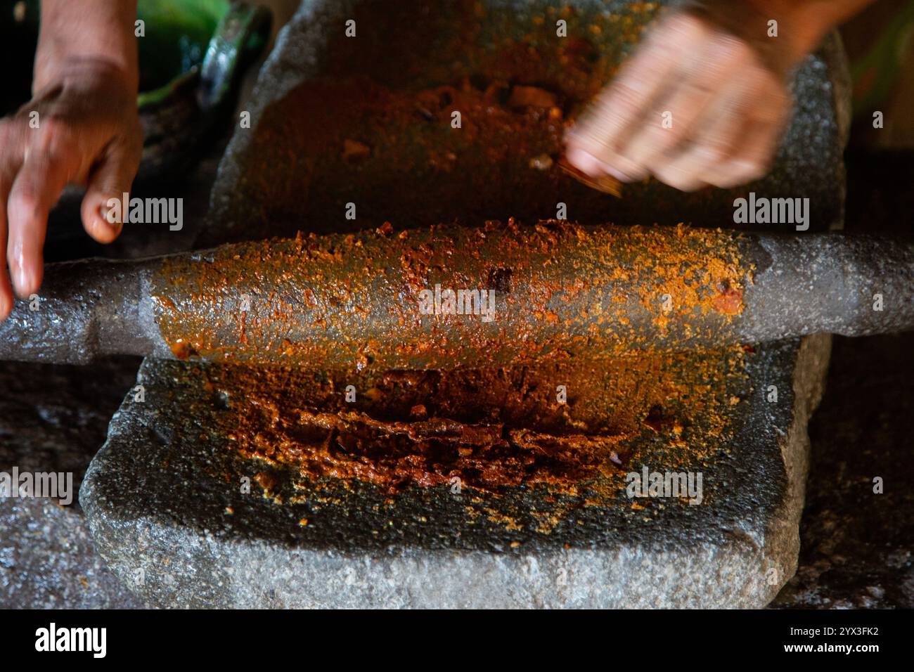 Woman from an indigenous community in Oaxaca preparing traditional red ...