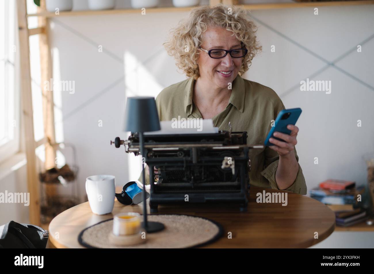 Happy businesswoman working with a typewriter and smarthpone Stock ...