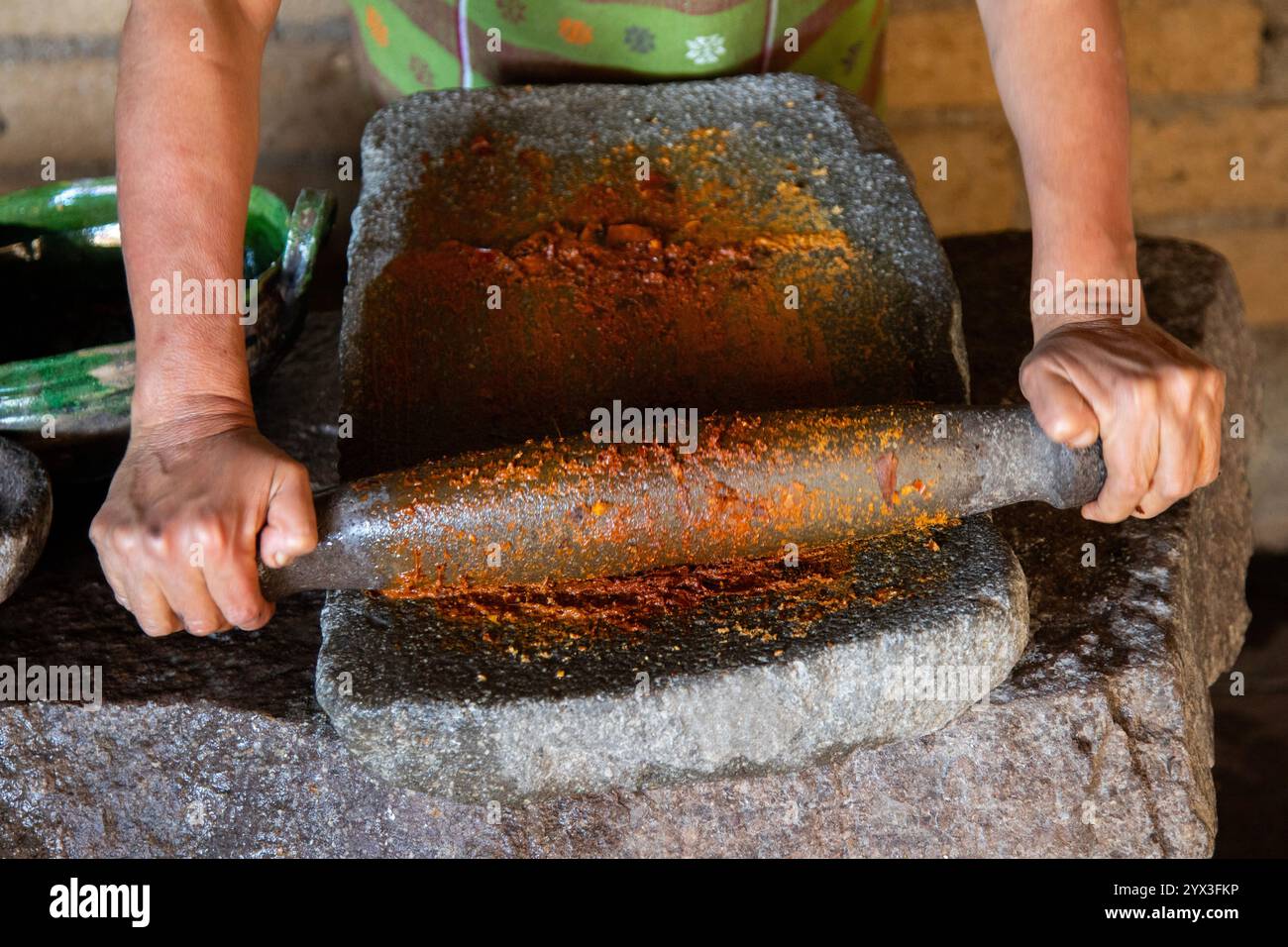 Woman from an indigenous community in Oaxaca preparing traditional red ...