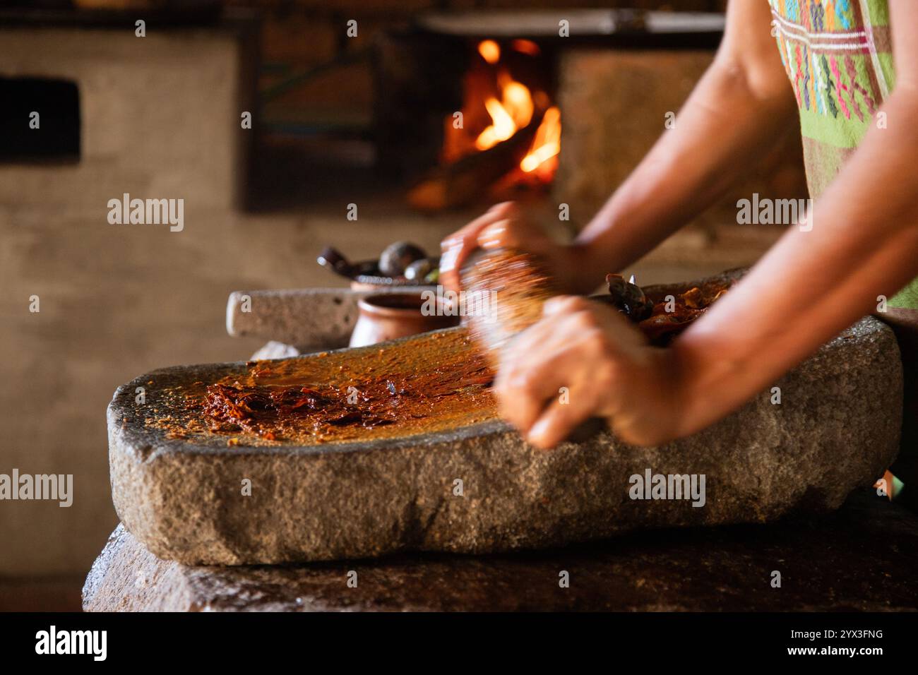 Woman from an indigenous community in Oaxaca preparing traditional red ...