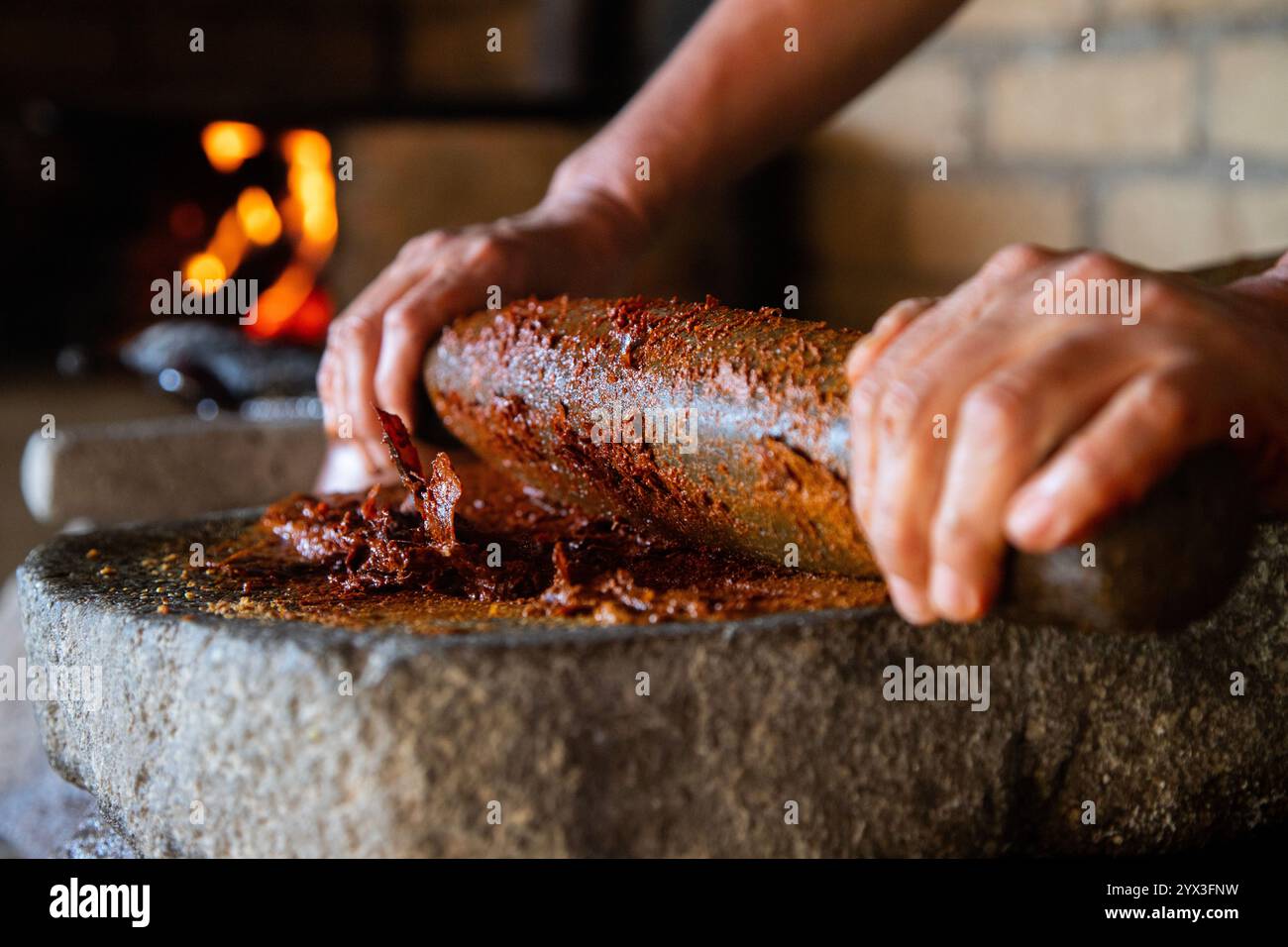 Woman from an indigenous community in Oaxaca preparing traditional red ...