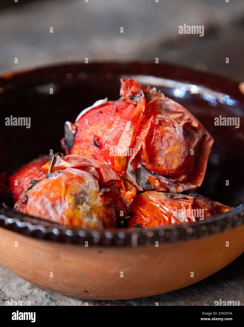 Tomatoes roasted on a Mexican comal to prepare a red mole in the Oaxaca ...