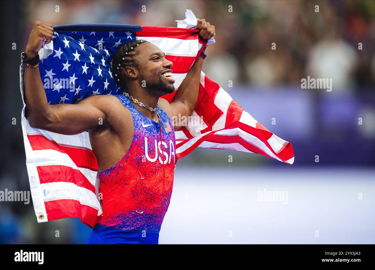 Noha Lyles celebrating her medal with her country's flag at the Paris ...