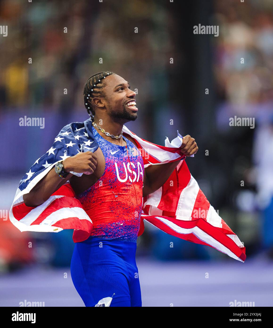 Noha Lyles celebrating her medal with her country's flag at the Paris ...