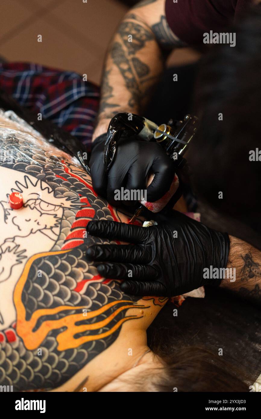 Hands woman tattooing man hi-res stock photography and images - Alamy