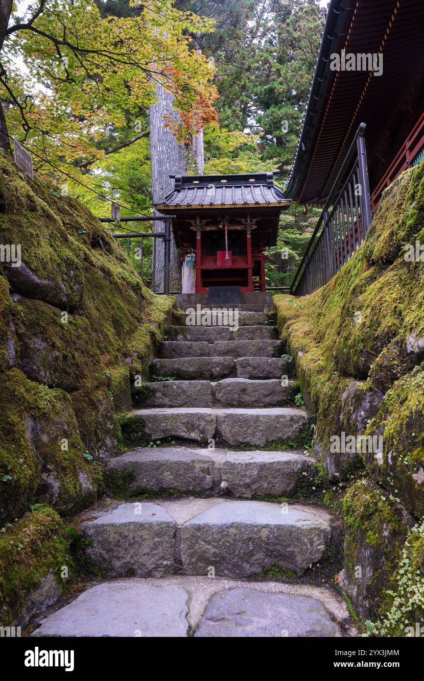 Stone steps lead up to a small hidden shrine Stock Photo - Alamy