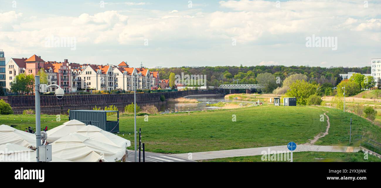 The waterfront of the Warta River in Poznań, with a promenade along the ...