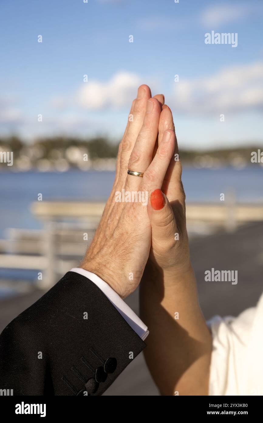 Couple's hands placed tenderly on each other Stock Photo - Alamy
